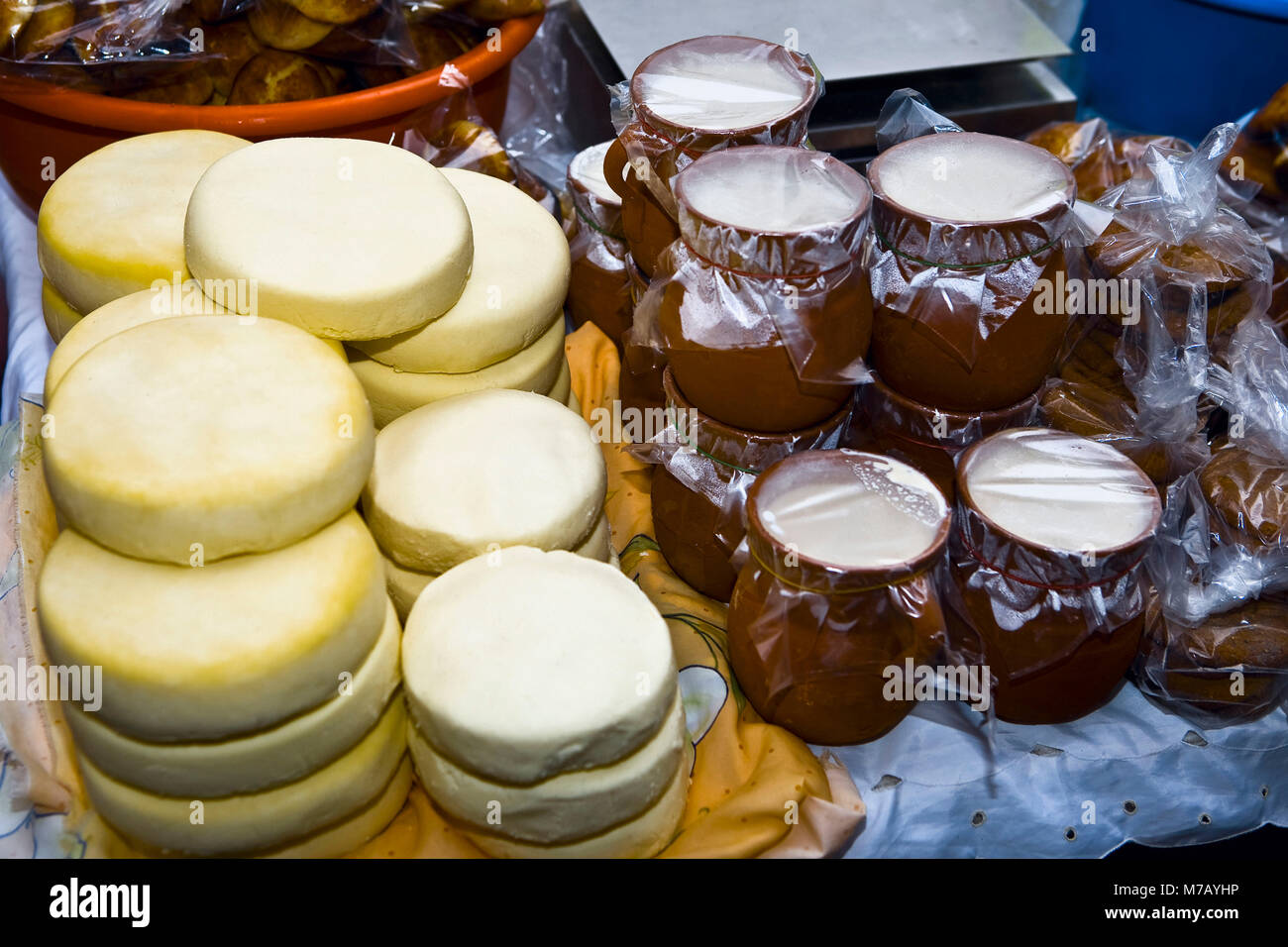 High angle view of stacks of cheese with tofu jars at a market stall ...