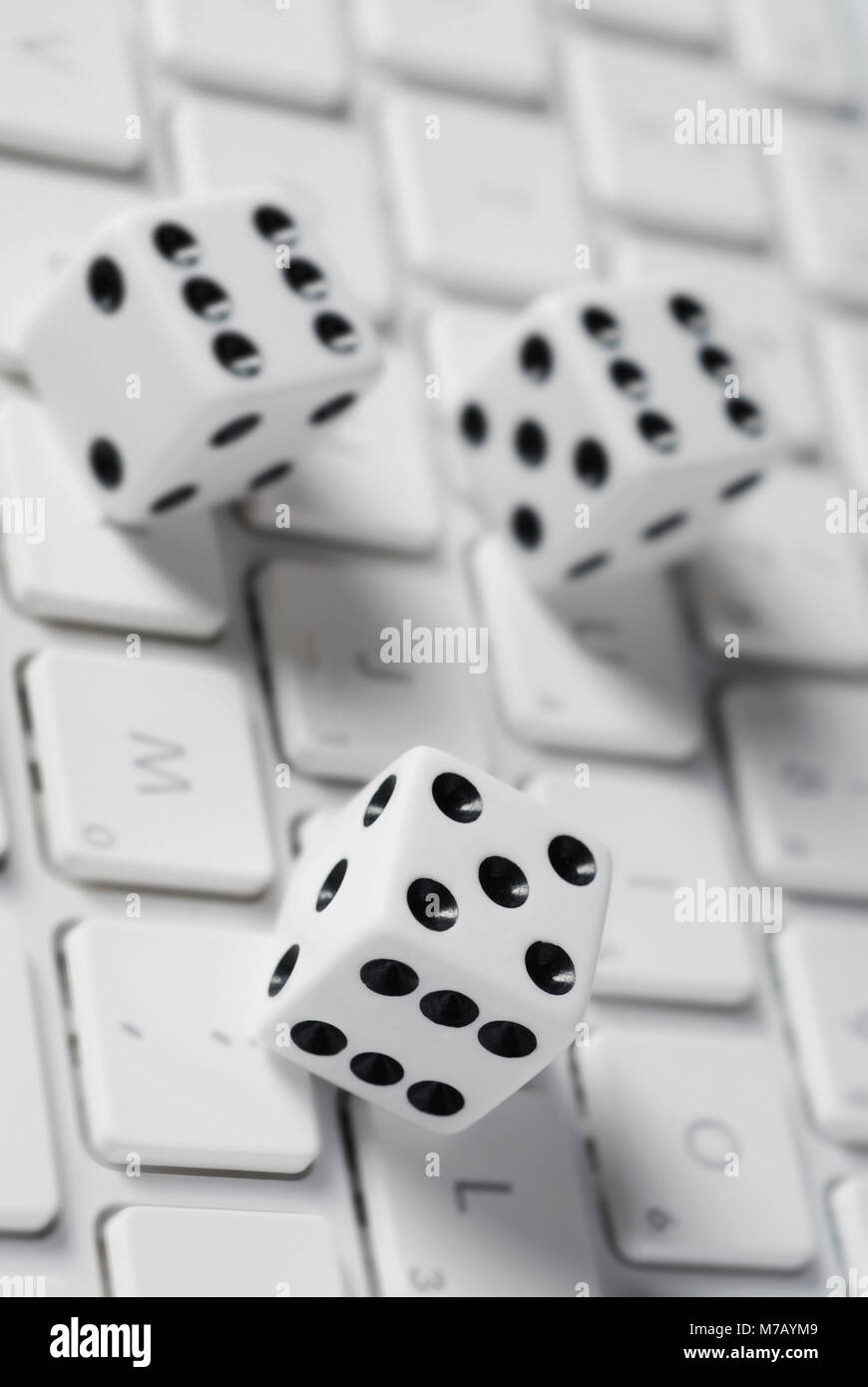 Close-up of three dice on a computer keyboard Stock Photo - Alamy