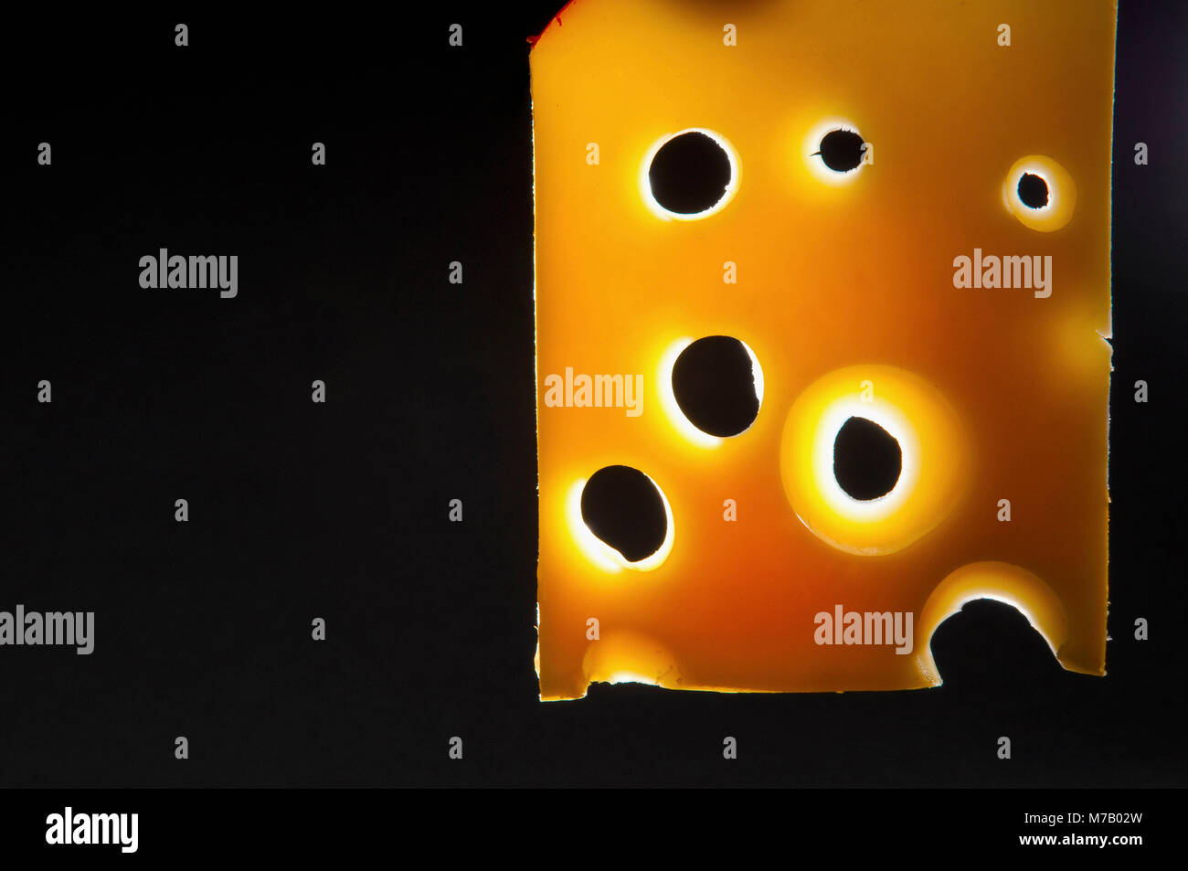 Slice of emmenthal cheese Stock Photo - Alamy