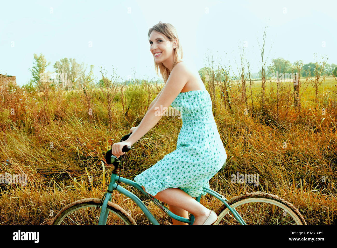 Woman riding a bicycle Stock Photo - Alamy