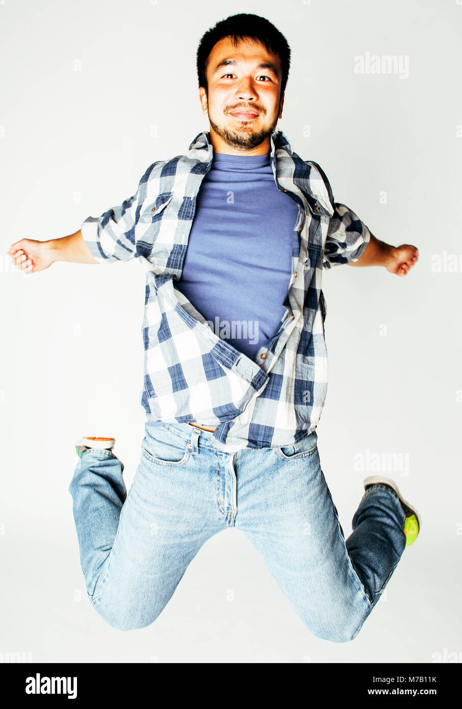 young pretty asian man jumping cheerful against white background Stock ...