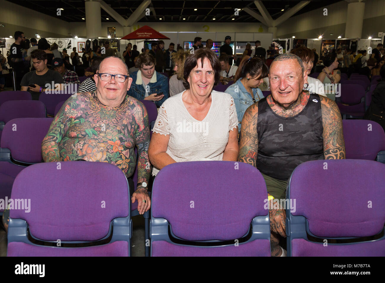 Three male friends relax at the Australian Tattoo Expo, International ...