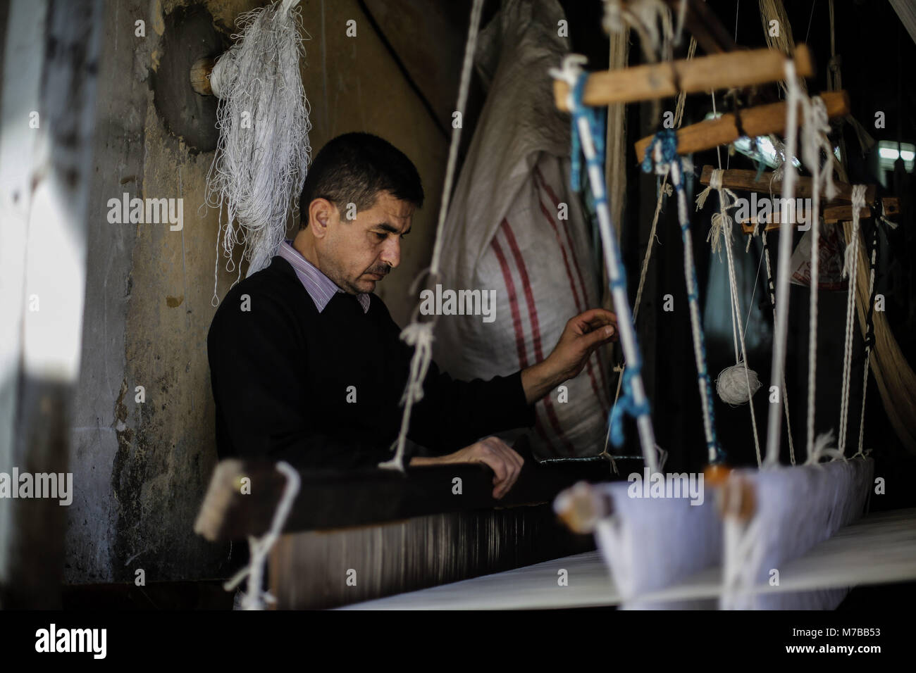 dpatop - A Palestinian man hand-weaves a carpet on a manual loom in ...