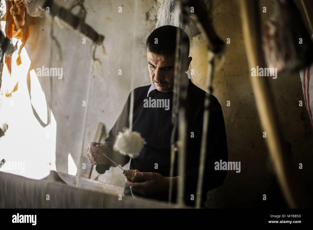dpatop - A Palestinian man hand-weaves a carpet on a manual loom in ...