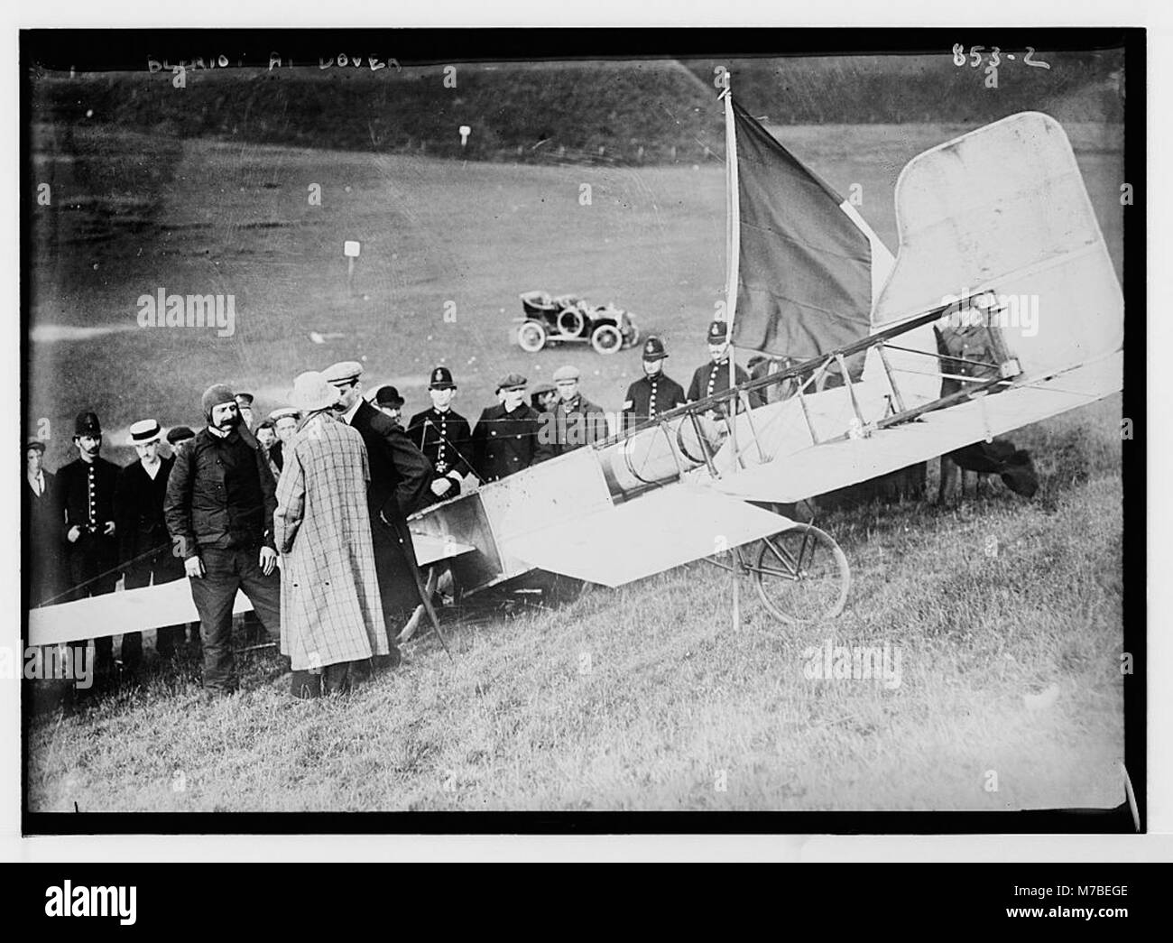 Louis Bleriot, a pioneer in aviation, stands next to his aeroplane on a ...