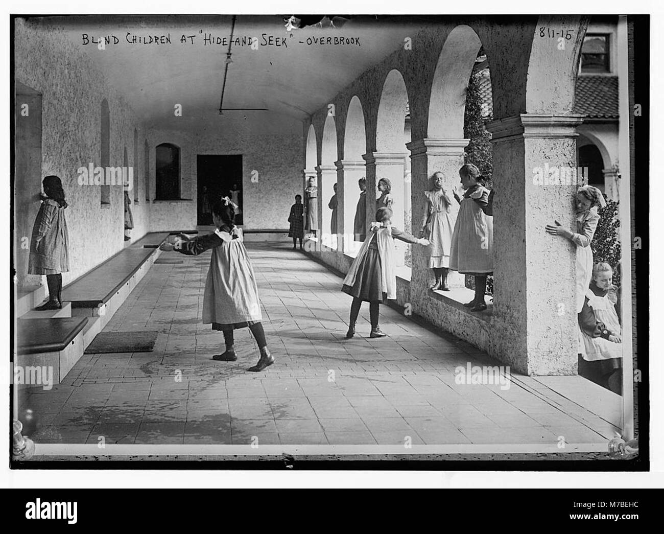 A photograph showing blind children playing 'hide and seek' around ...