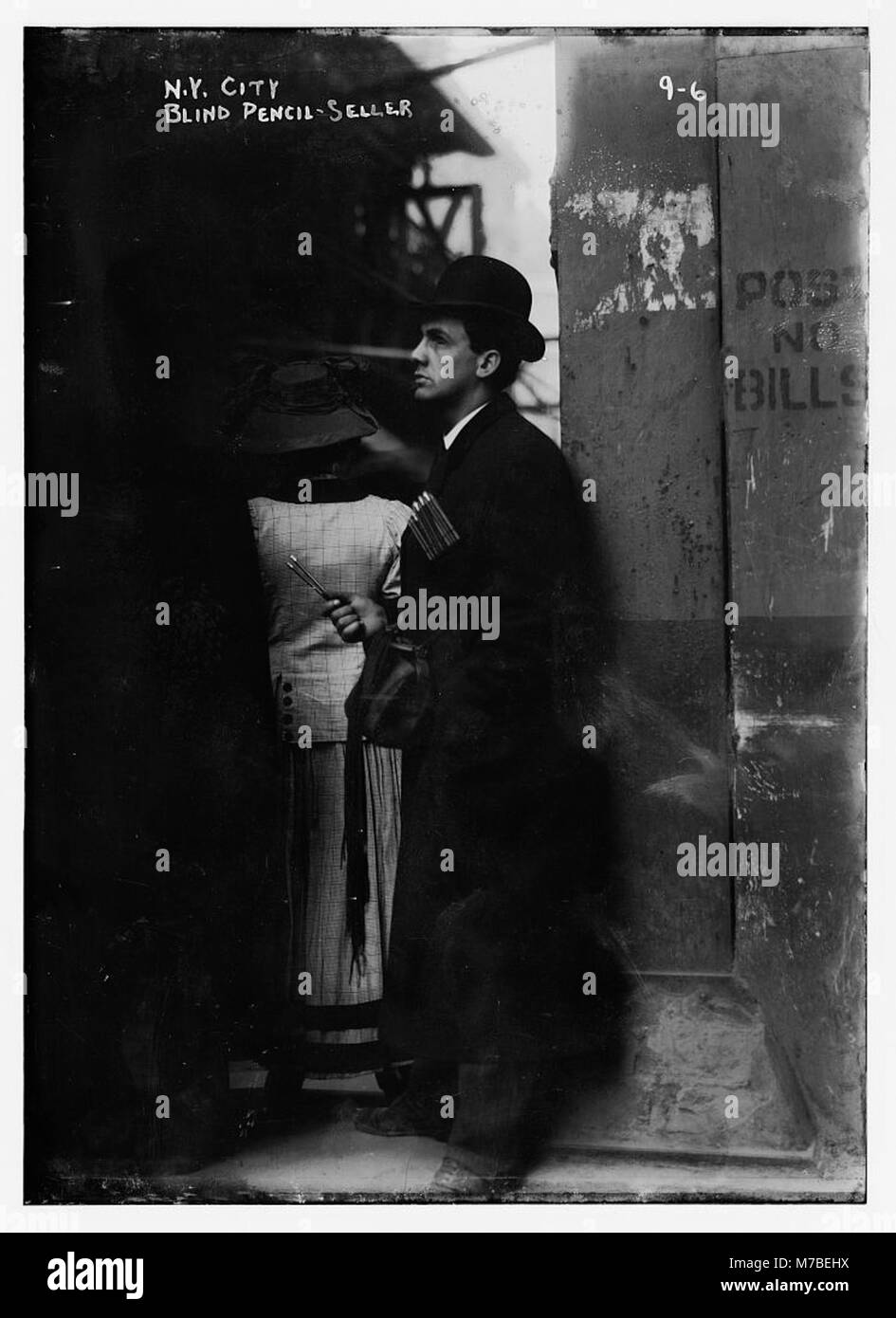 This image depicts a blind pencil seller, showing the individual ...