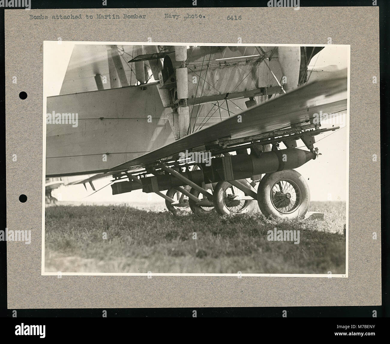 A historical Navy photograph depicting bombs attached to a Martin ...