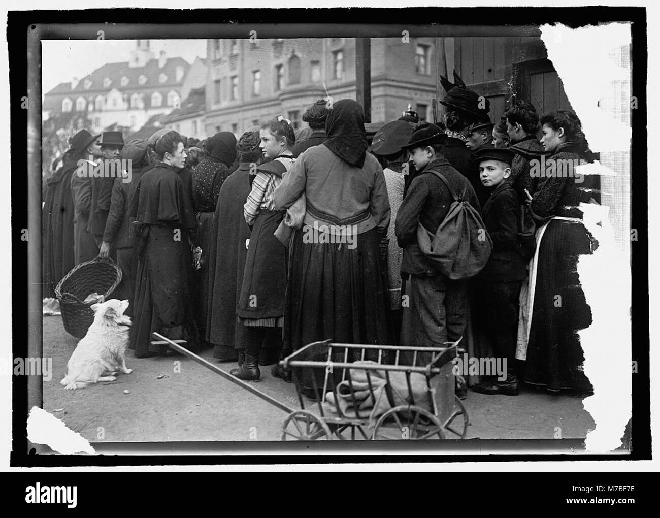 A historical photograph depicting people standing in bread lines in ...