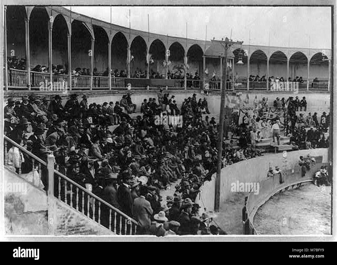 This photograph captures a bullfight in Mexico, with spectators ...