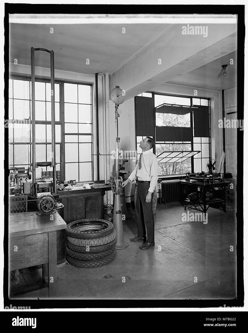 A scene at the Bureau of Standards where testing of rubber materials is ...