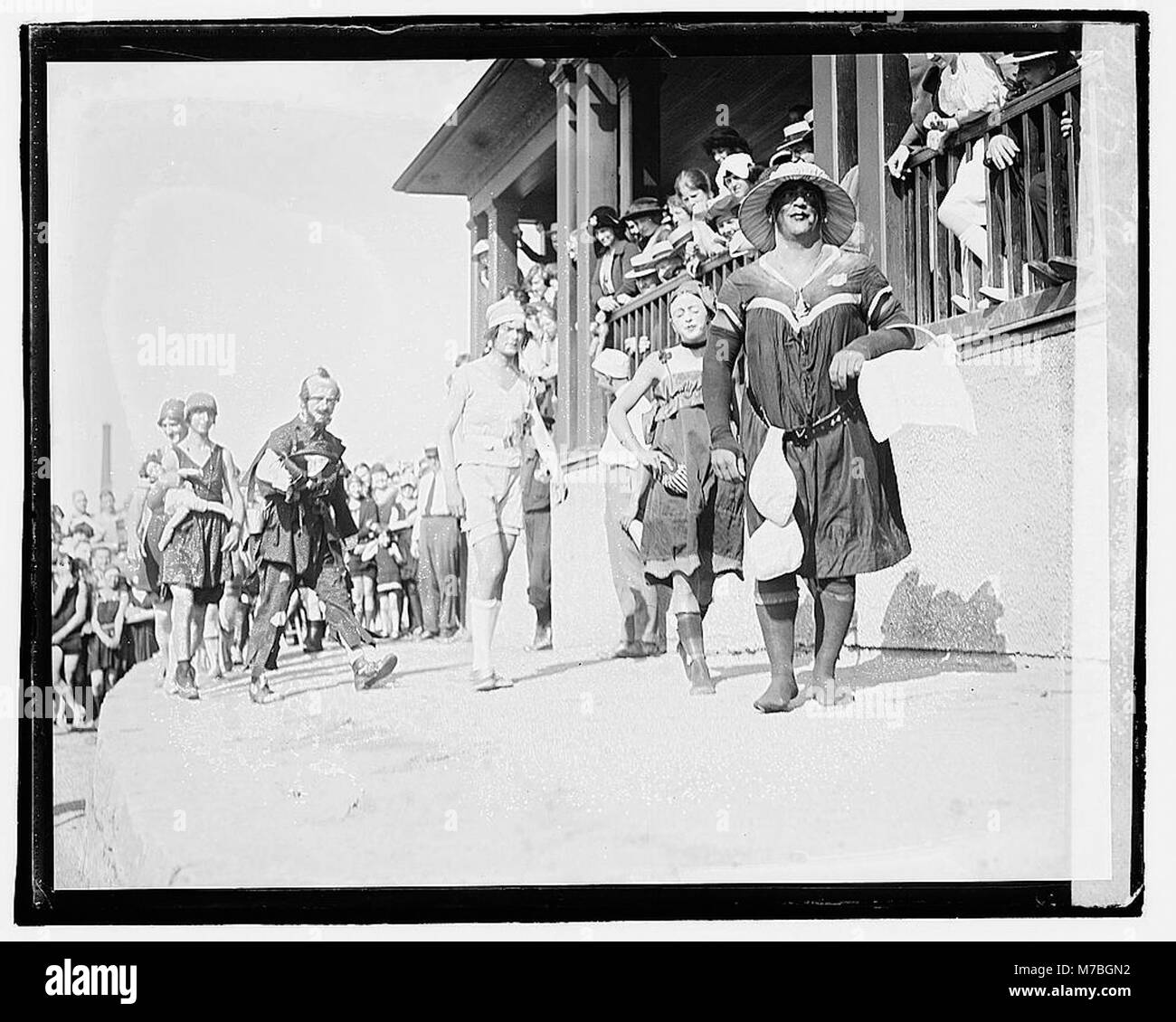 A photograph capturing people eating cake on a bathing beach, providing ...