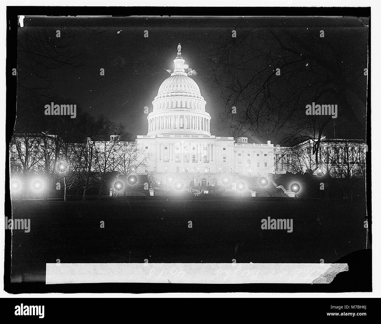 A night view of the United States Capitol building, illuminated against ...