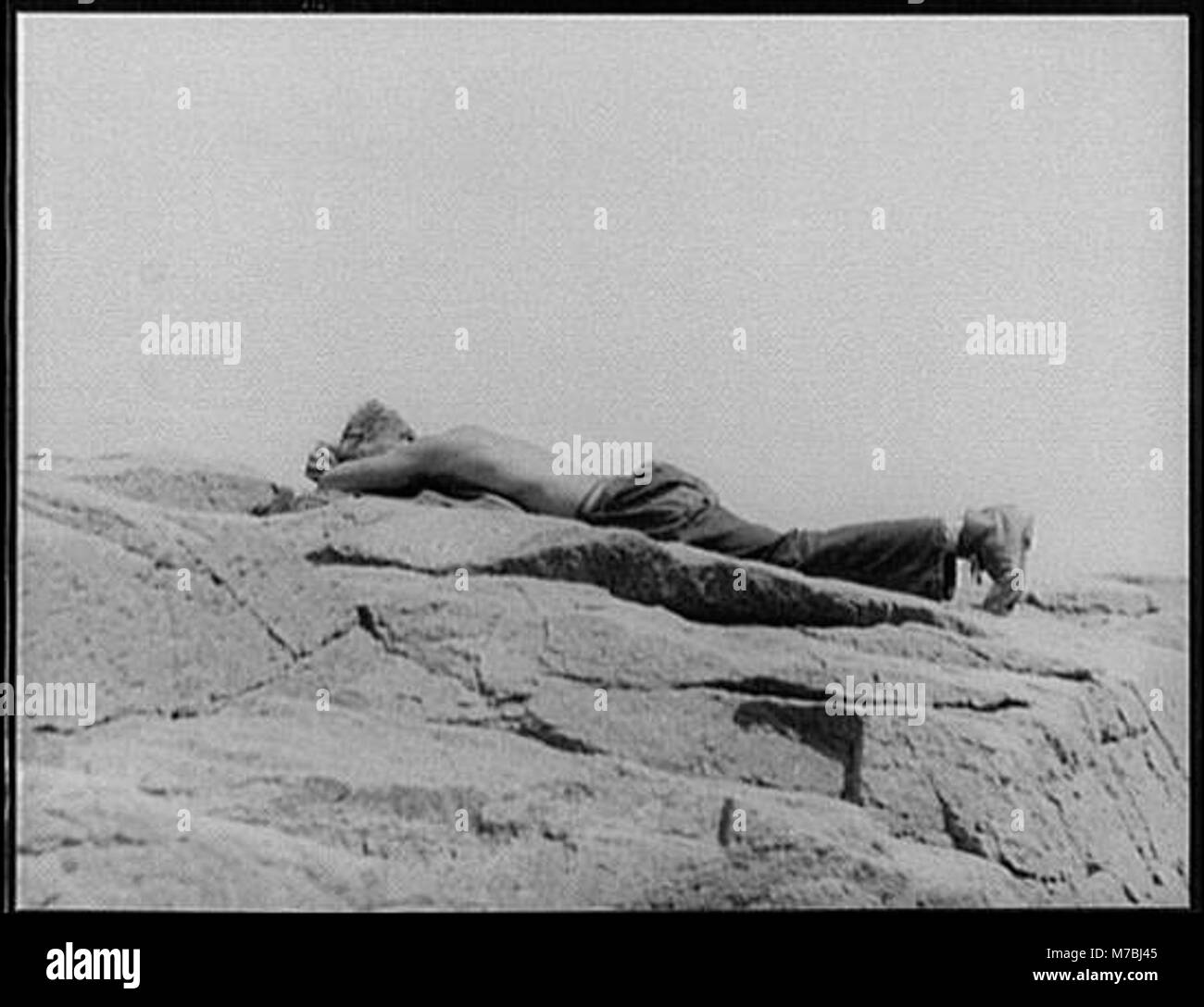 This image shows a Civilian Conservation Corps (CCC) worker asleep at ...