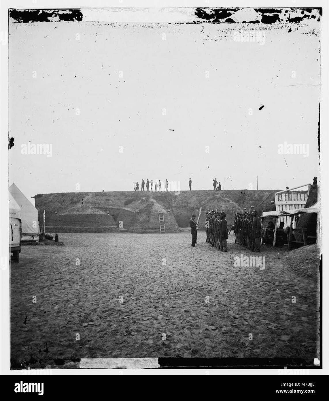A historical photograph depicting soldiers mounting guard at Fort ...