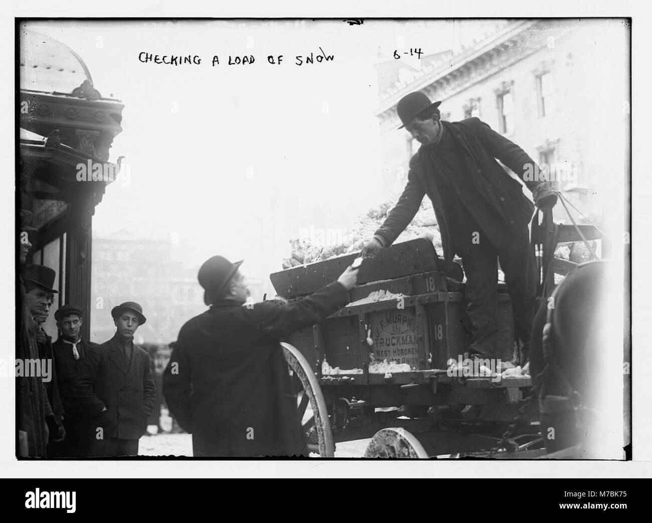 A photograph of workers checking a load of snow in New York, capturing ...