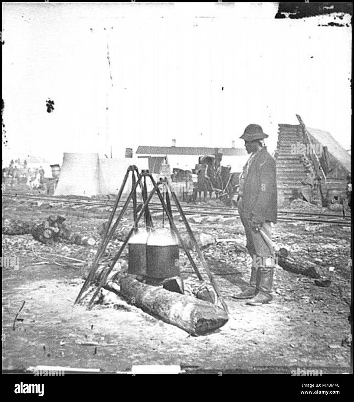 This photograph shows an African American army cook at work in City ...
