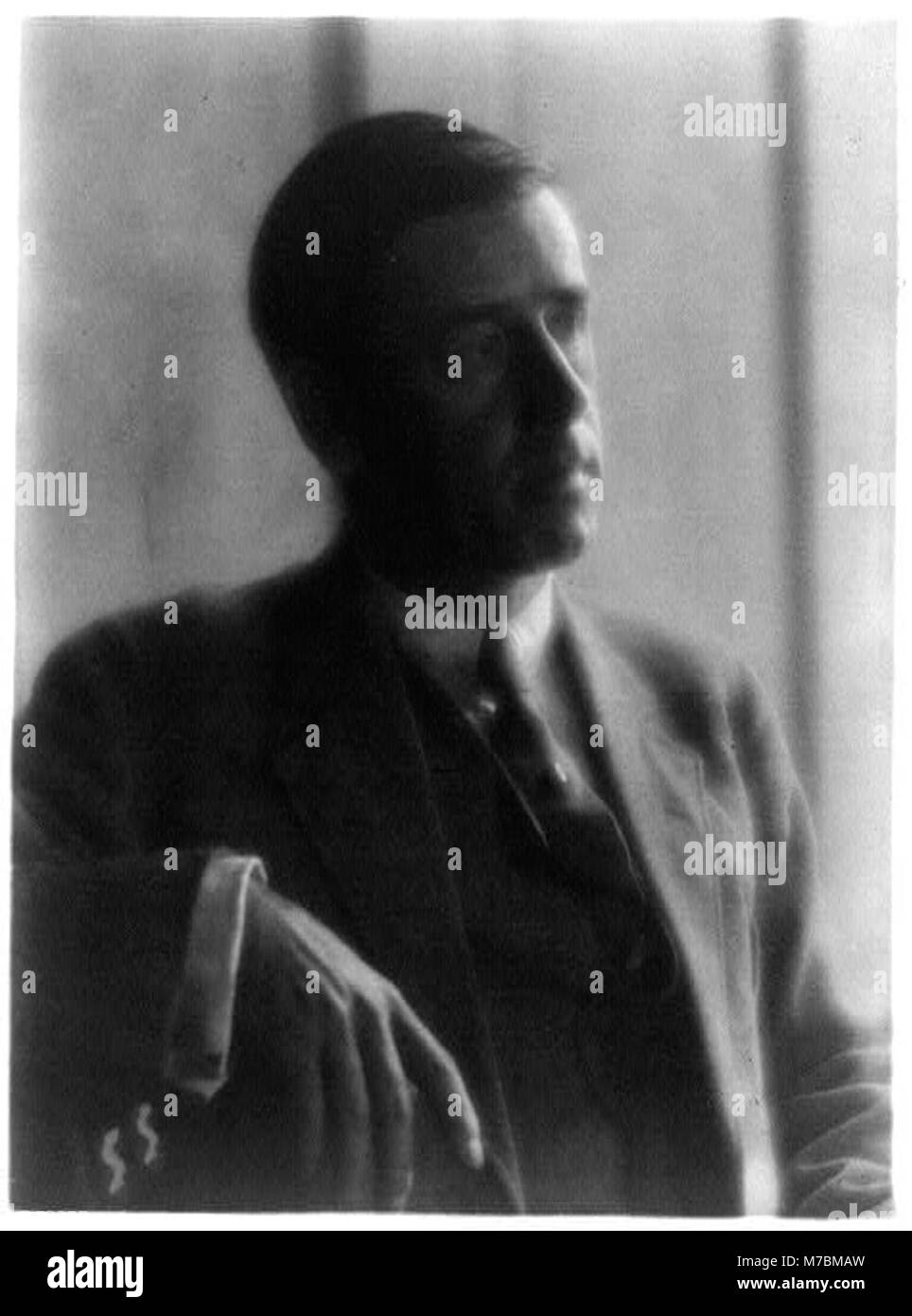 A portrait of Clarence White, shown seated in a suit, reflecting his ...