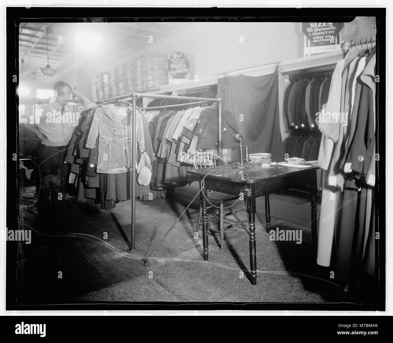 An interior view of a clothing store, showing displays of garments and ...