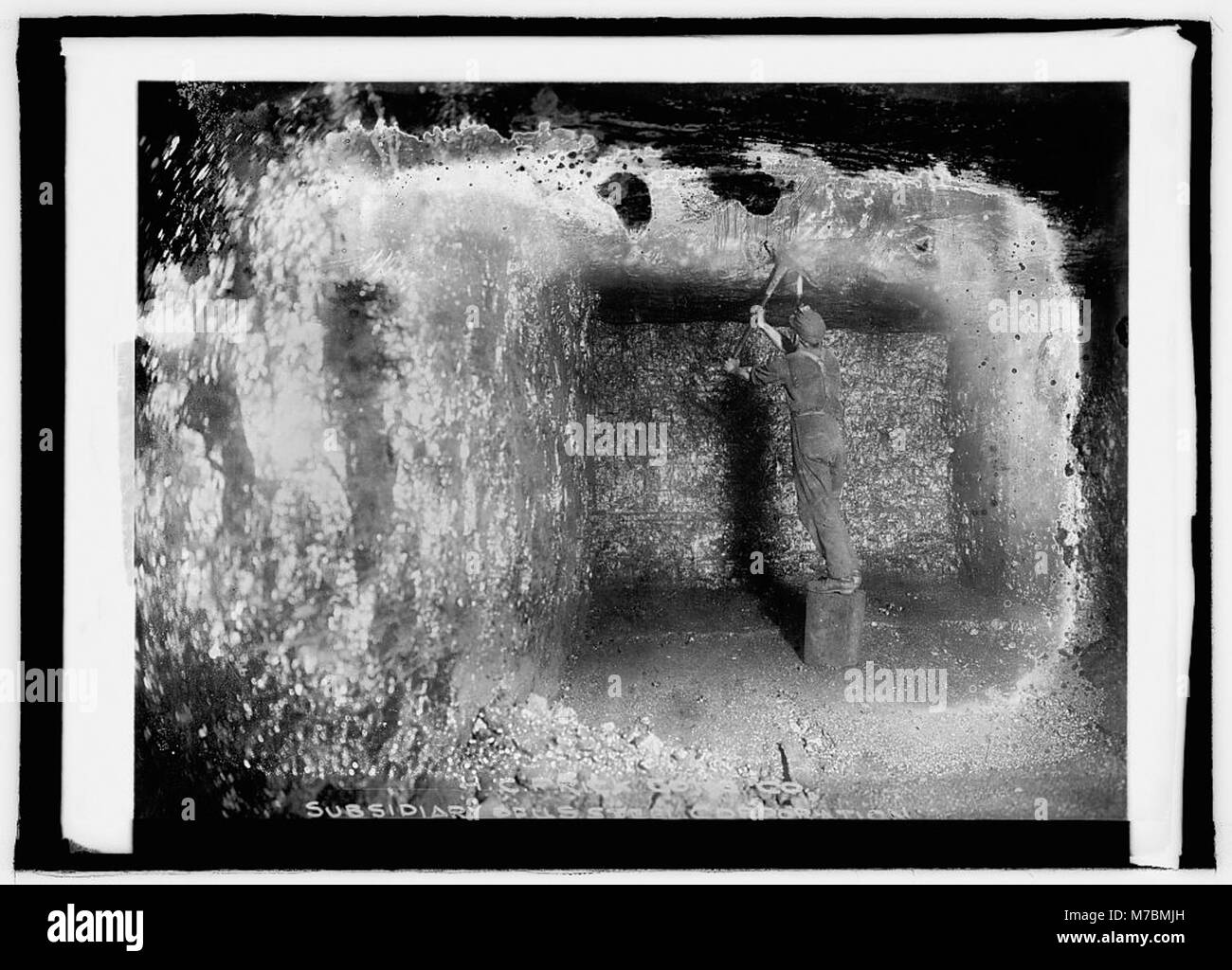 A photograph of coal miners working in a mine, capturing the harsh ...