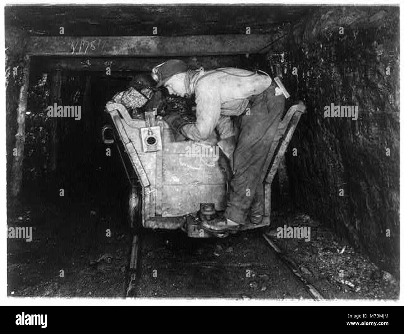 This photograph depicts scenes from coal mining, showcasing workers and ...