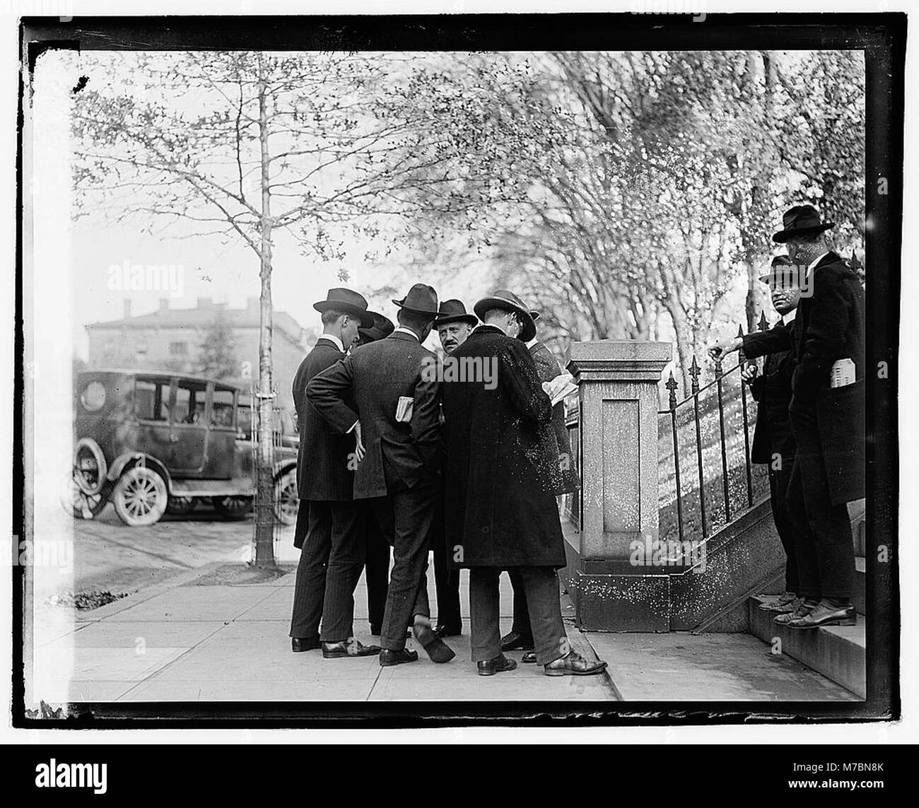 The image shows Colby and several newspaper men, possibly journalists ...