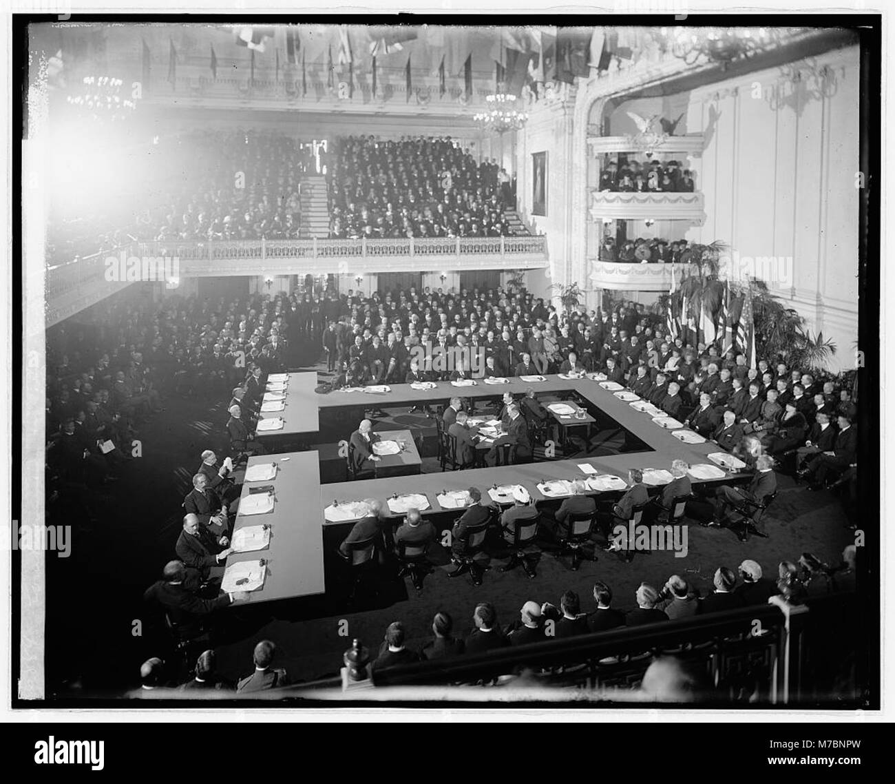 A photo depicting a conference in session, capturing participants ...