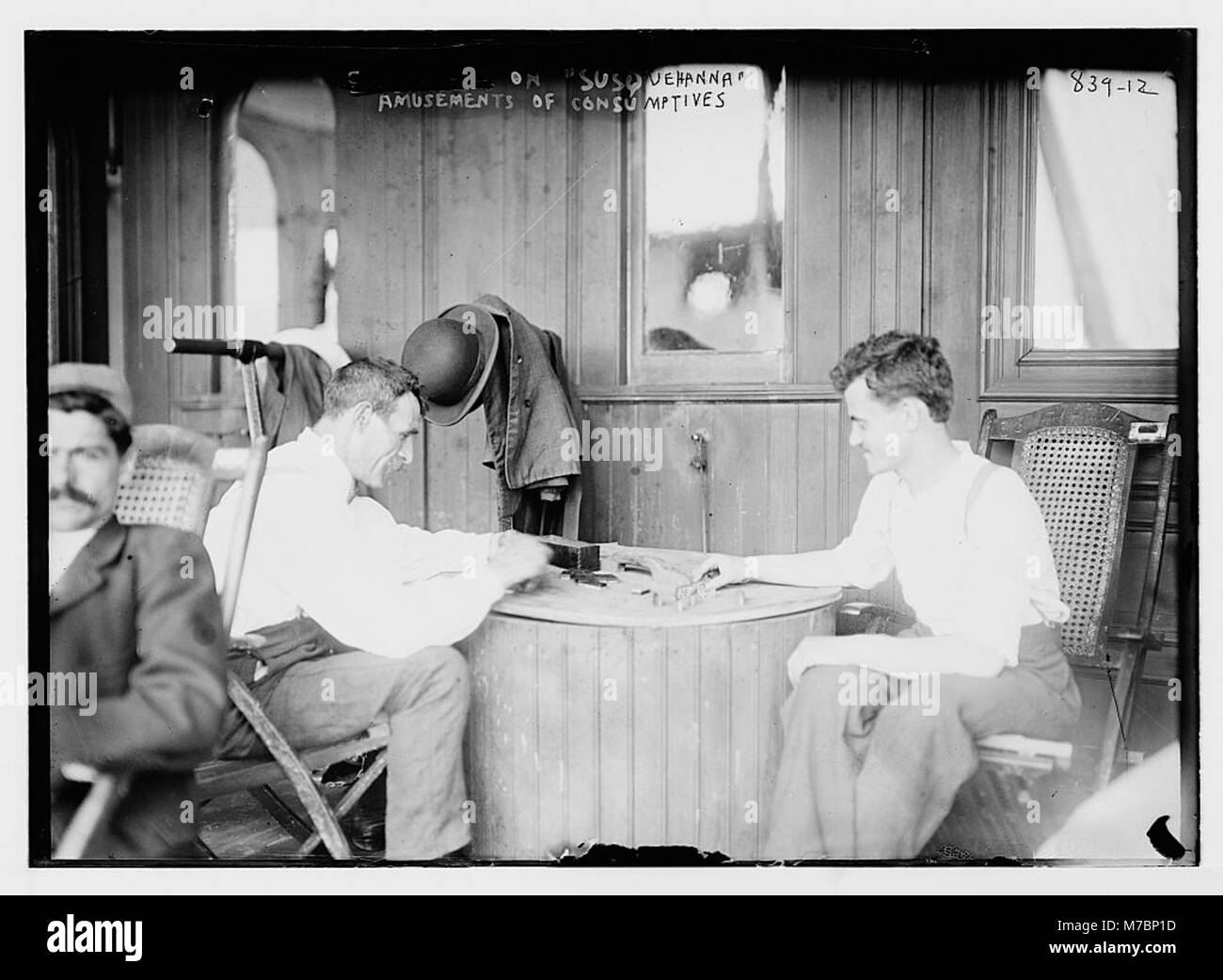 An image showing individuals with tuberculosis playing dominoes aboard ...