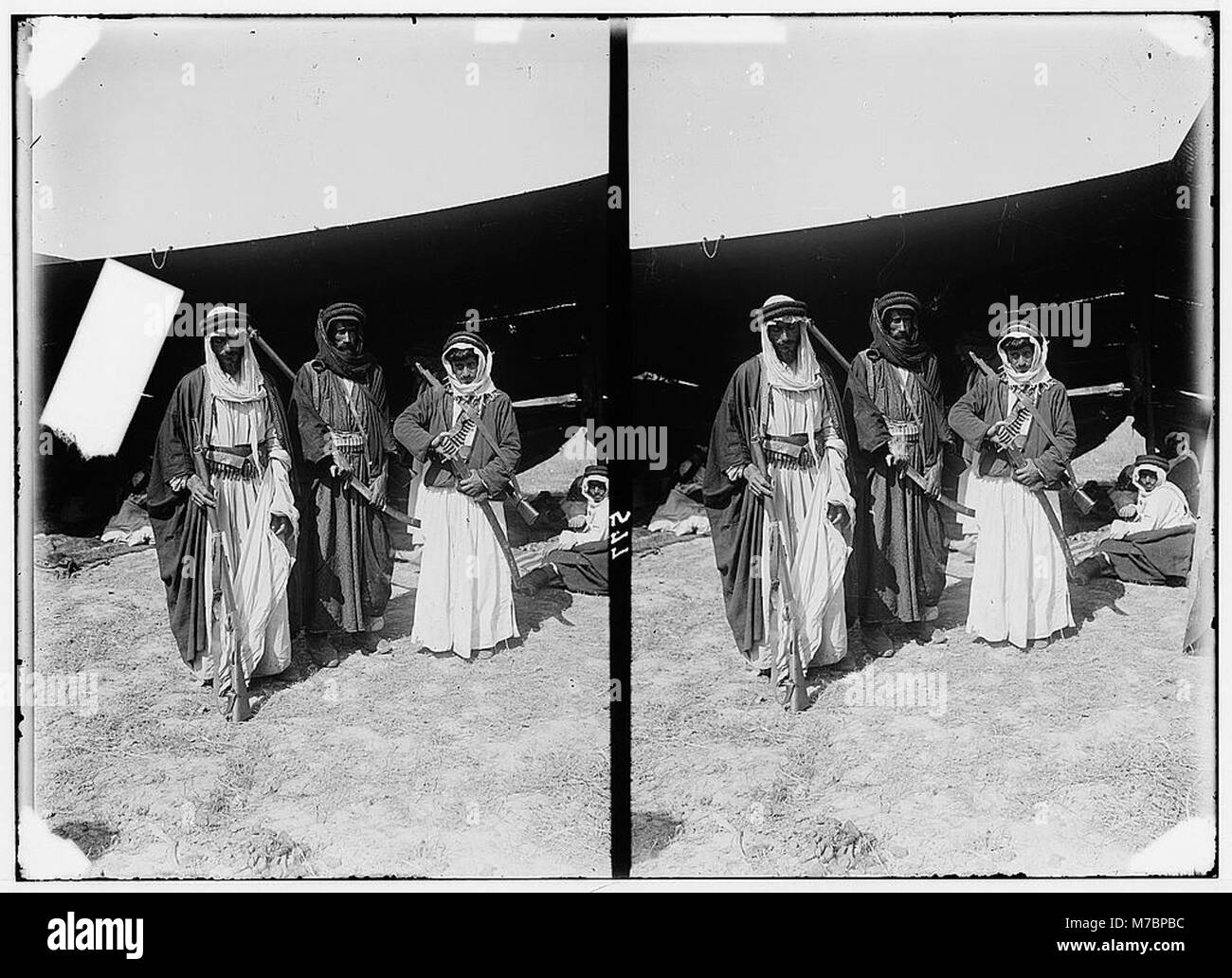 A group of Bedouins in traditional costumes, capturing their attire and ...