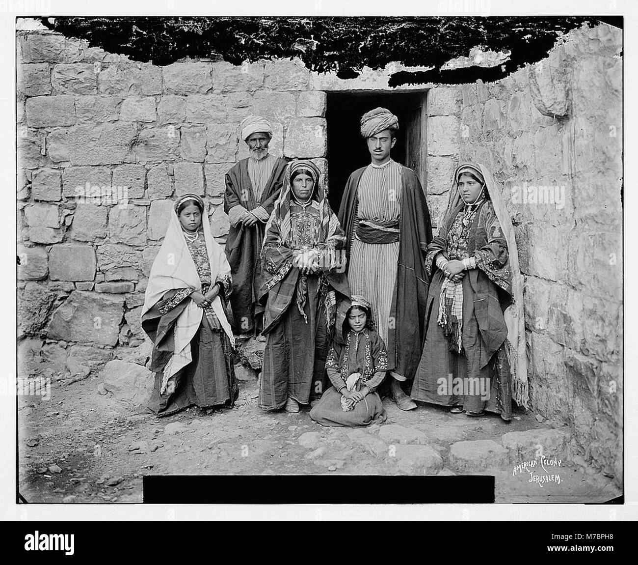 A family group is depicted in traditional costumes in Ramallah. The ...