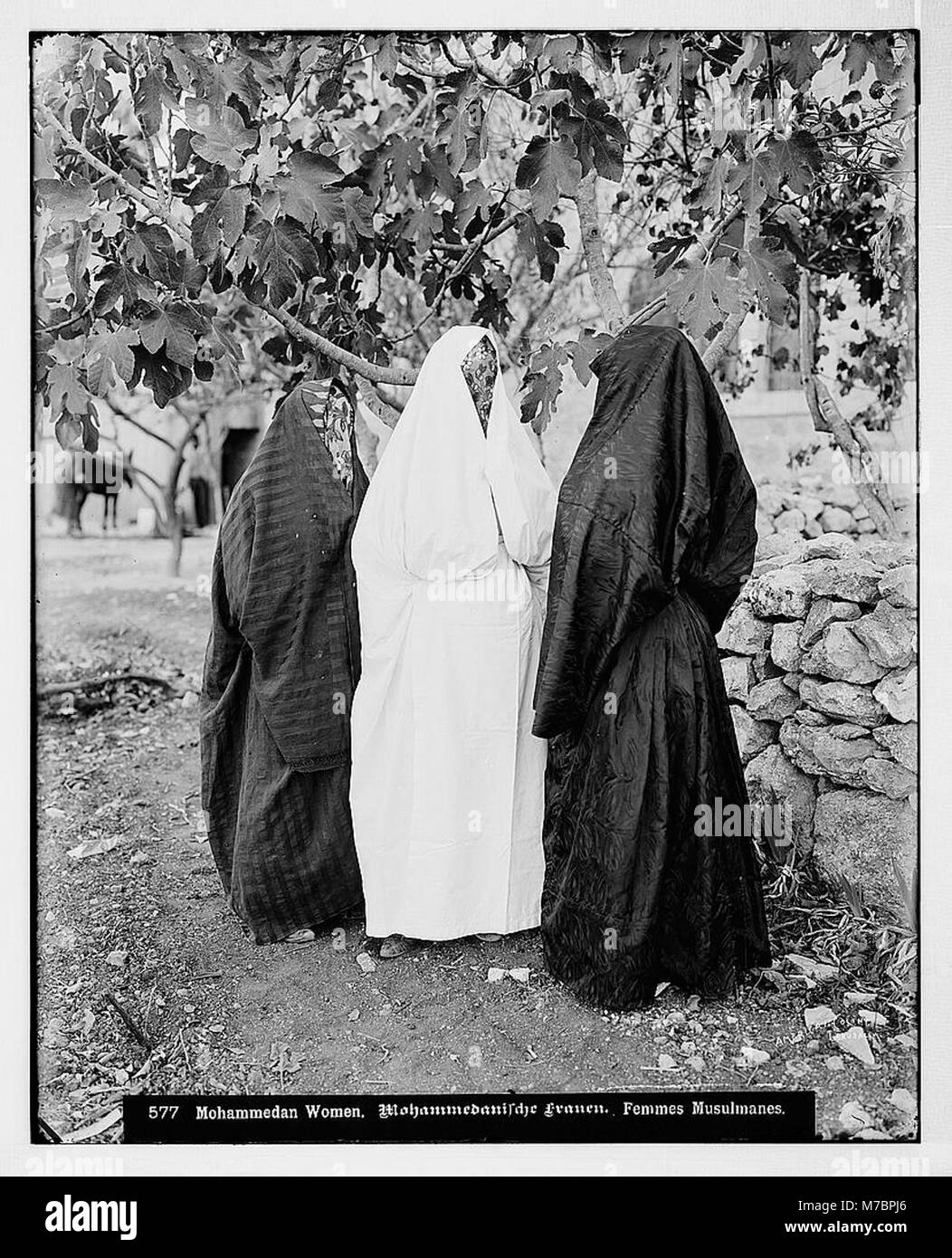 This image depicts veiled Muslim women in traditional costumes ...