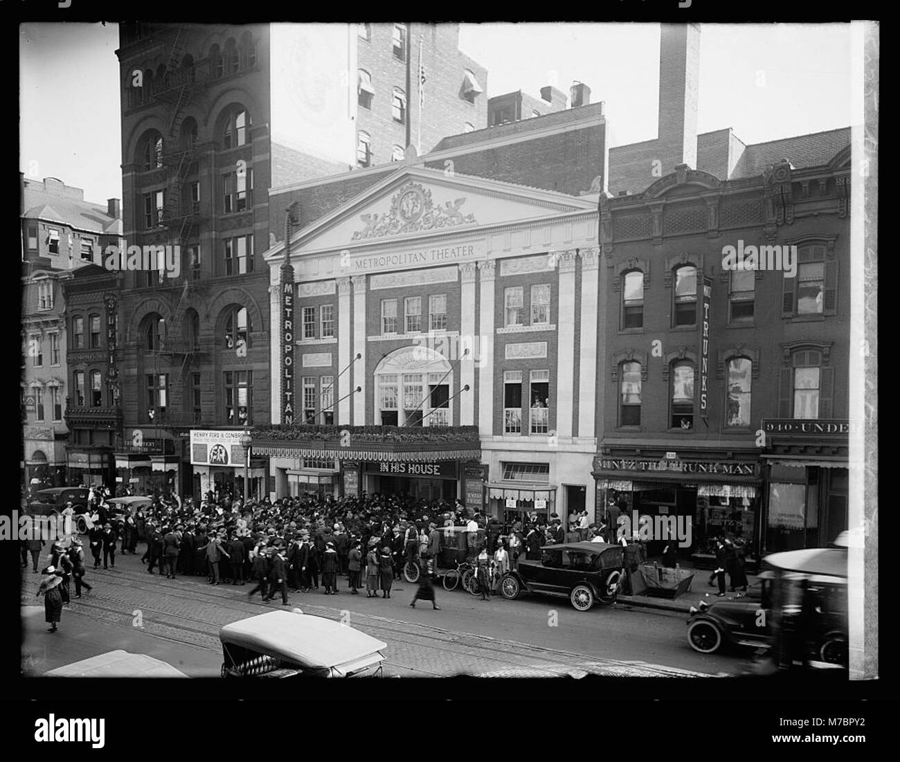 The photograph captures a crowd gathered outside the Metropolitan ...