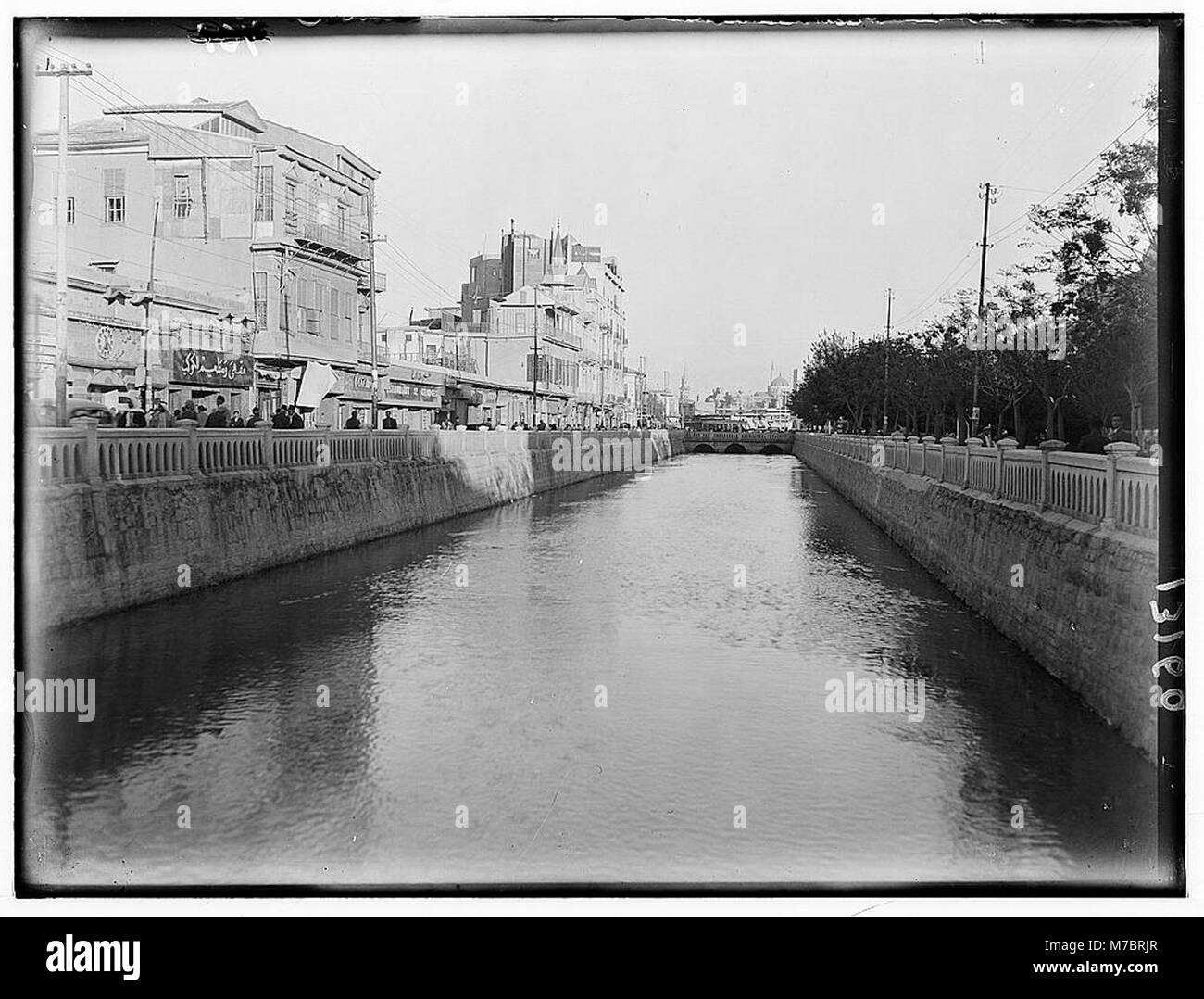 This photograph captures a view of Damascus from one of its bridges ...