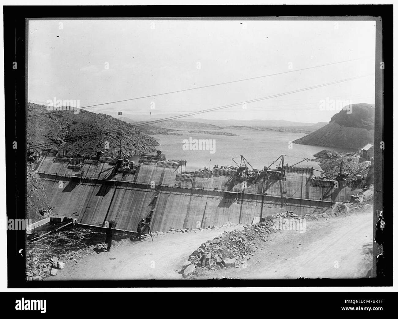 Photograph of a dam under construction, showcasing workers and ...