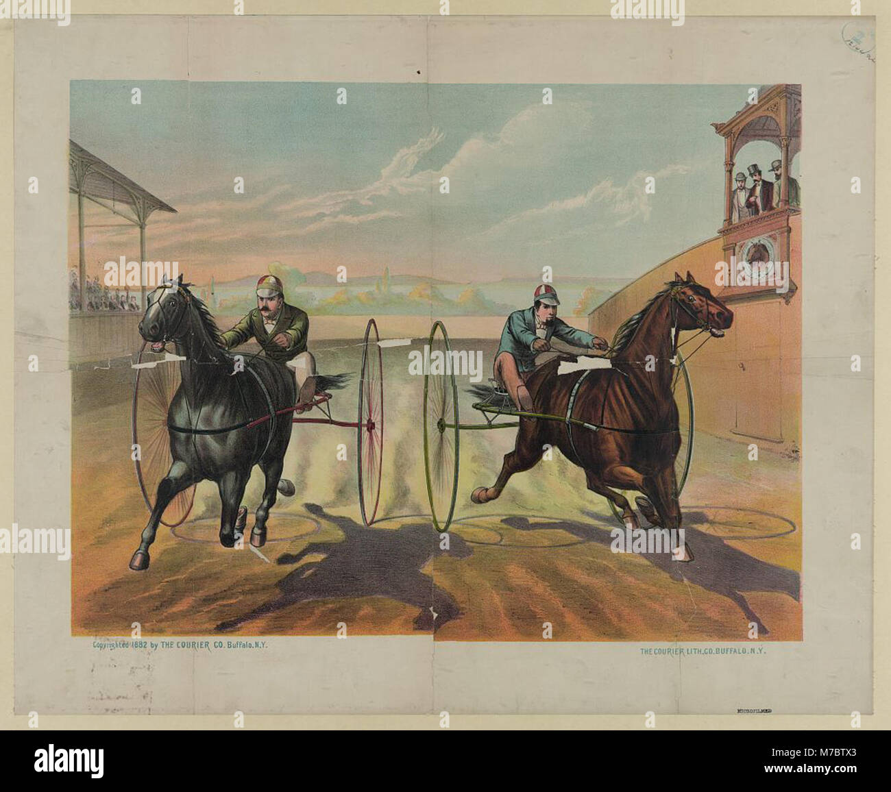 This image captures a moment from a sulky race, showcasing the ...