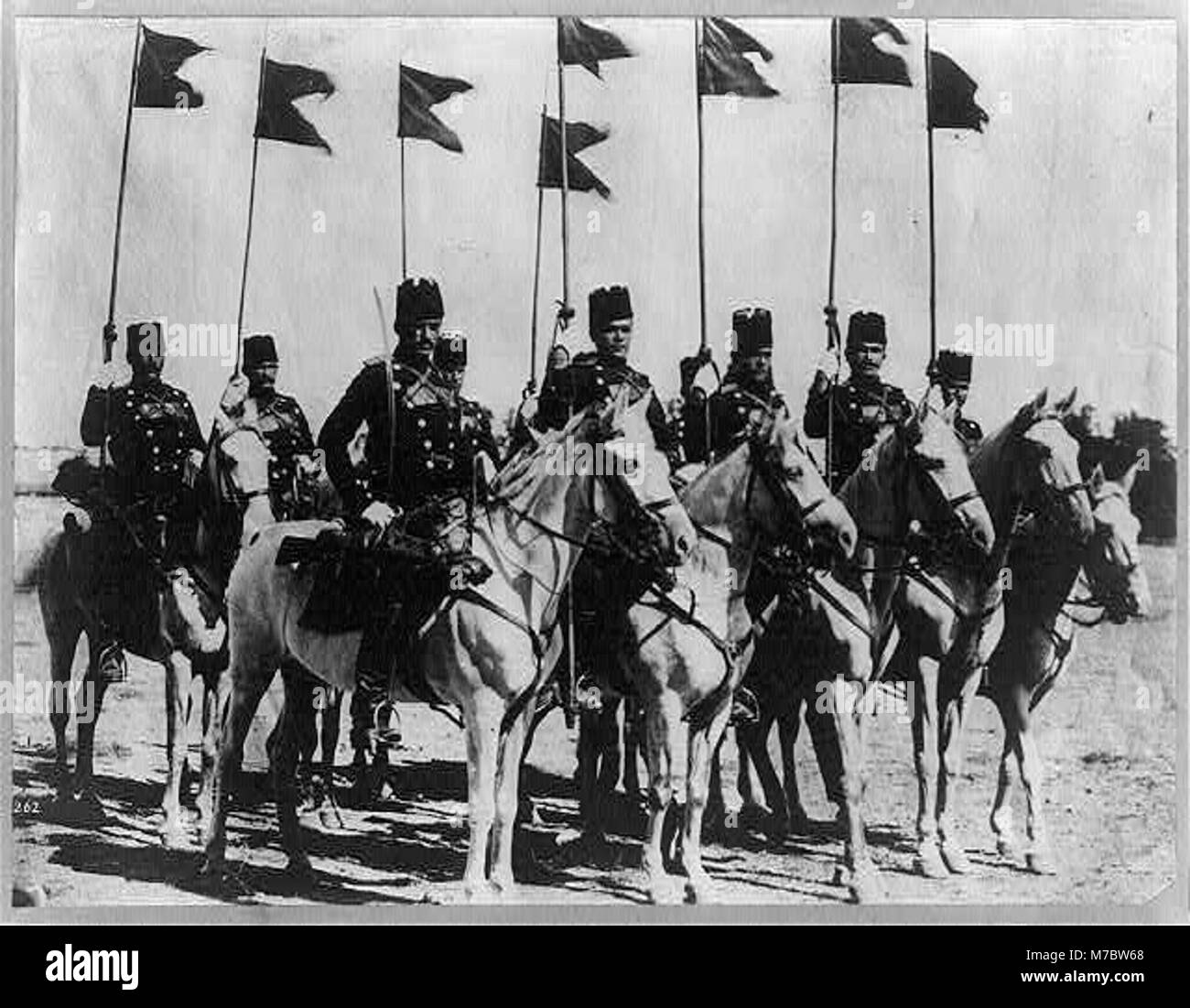 This image shows eight members of the Turkish cavalry riding horseback ...