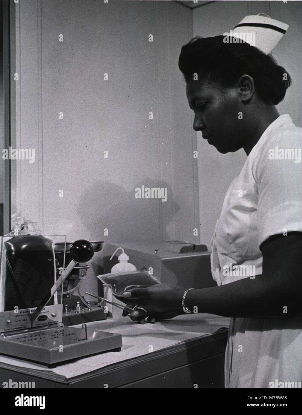 This image shows a nurse working at a blood bank, emphasizing the ...
