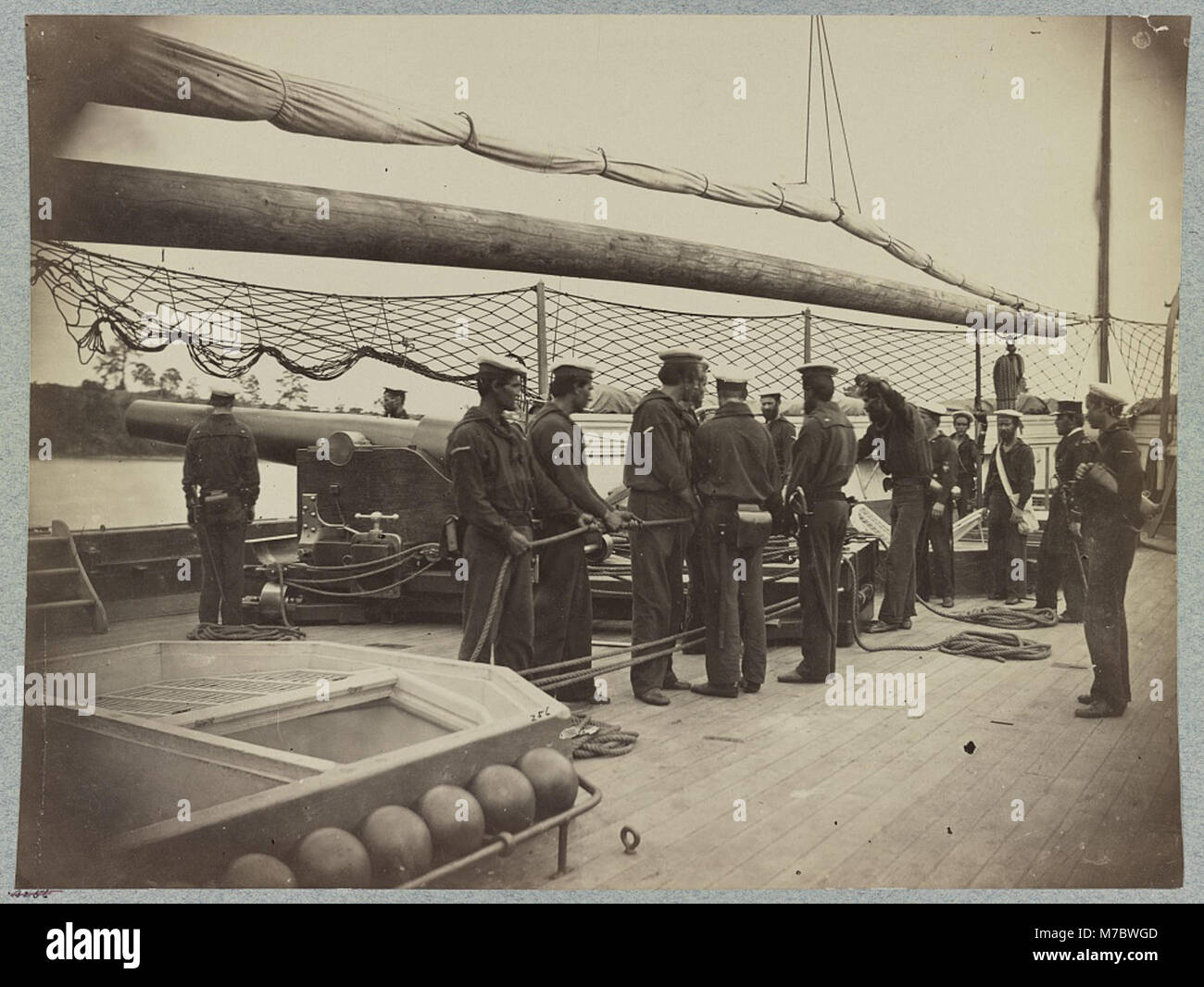 A photograph showing a gun crew on deck of the U.S.S. Mendota, an ...