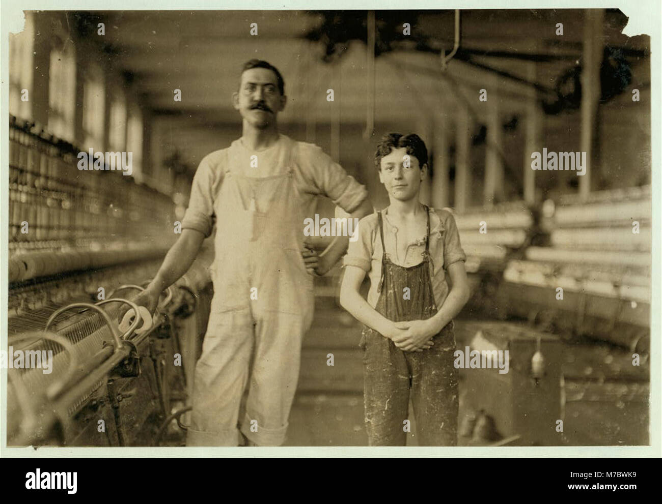 This image shows a mule-spinner and his assistant, Leopold Daigneau ...