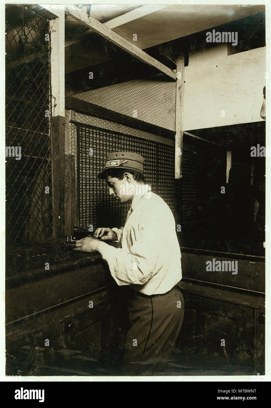 A Postal Telegraph boy learning to send messages during spare moments ...