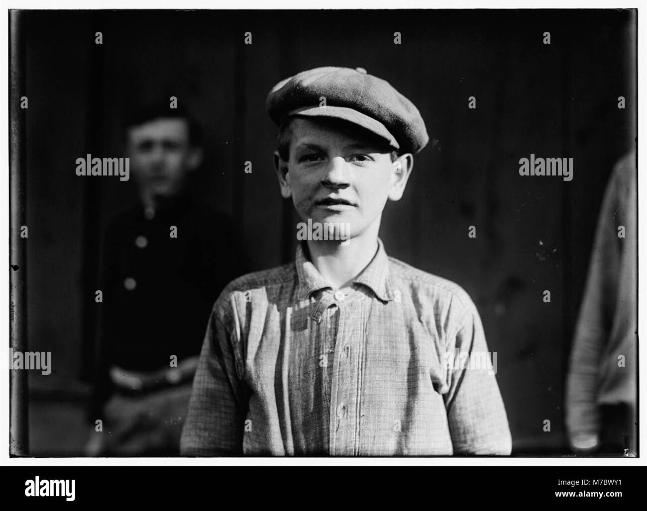 This image depicts a typical 'glass-boy' at the Woodbury Bottle Works ...