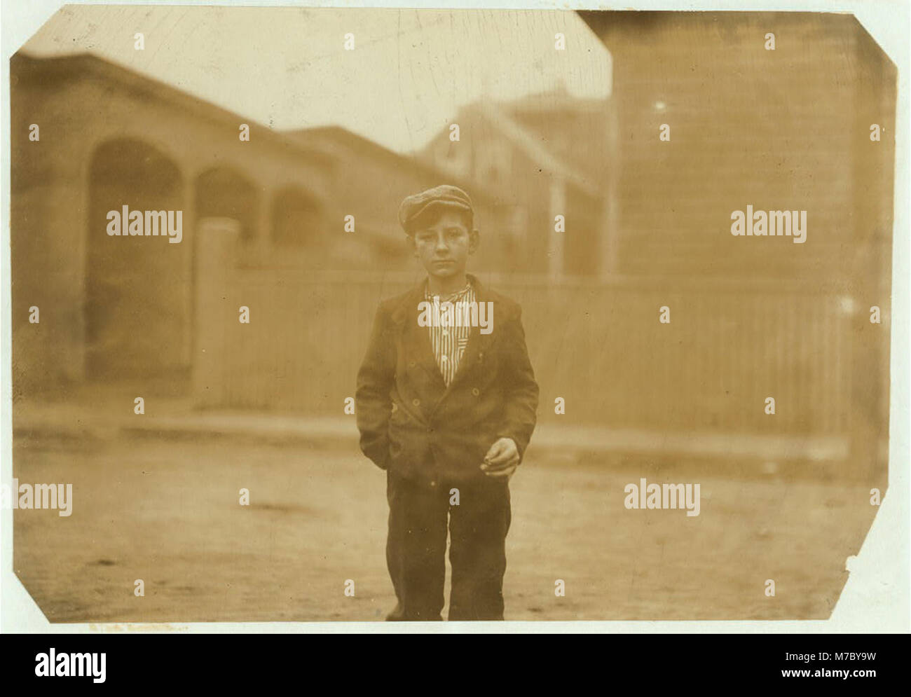 A photograph of Alfred Corriveau working in the spinning room on the ...