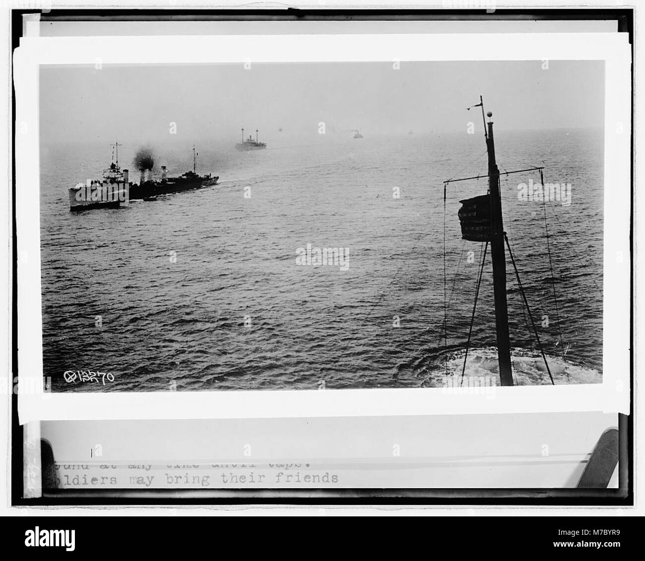 This image depicts an American destroyer escorting troops into the ...