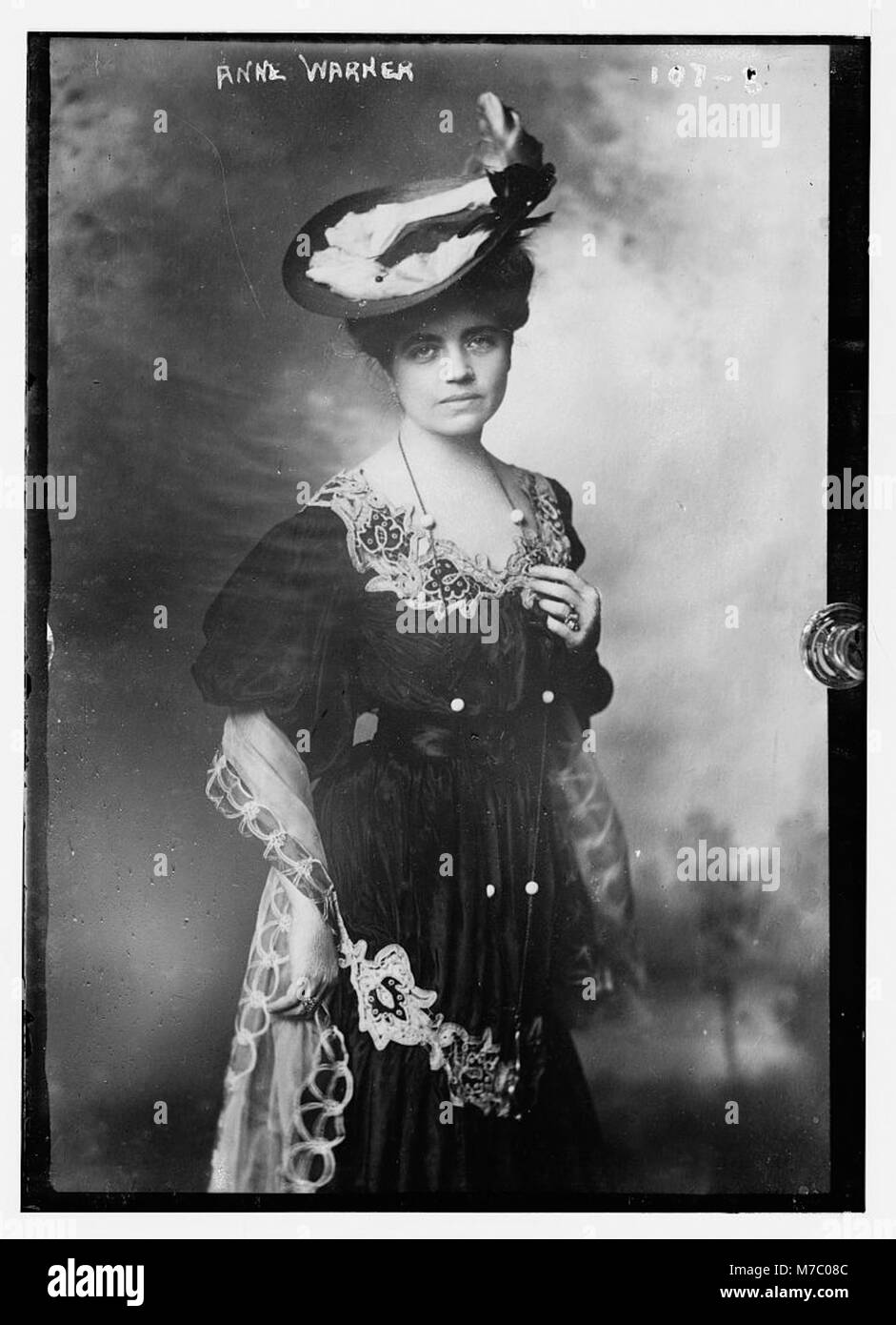 A portrait of Anne Warner, captured in a three-quarters standing pose ...