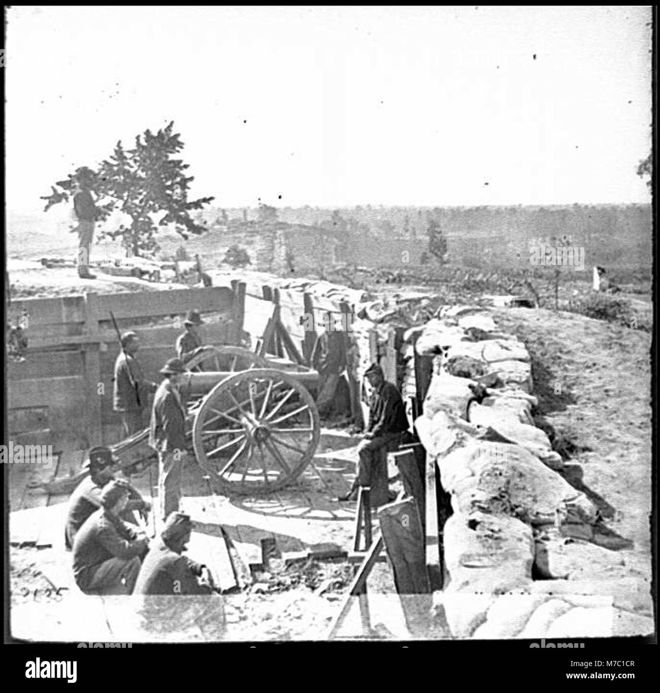 A historical photograph showing Federal soldiers positioned by a cannon ...