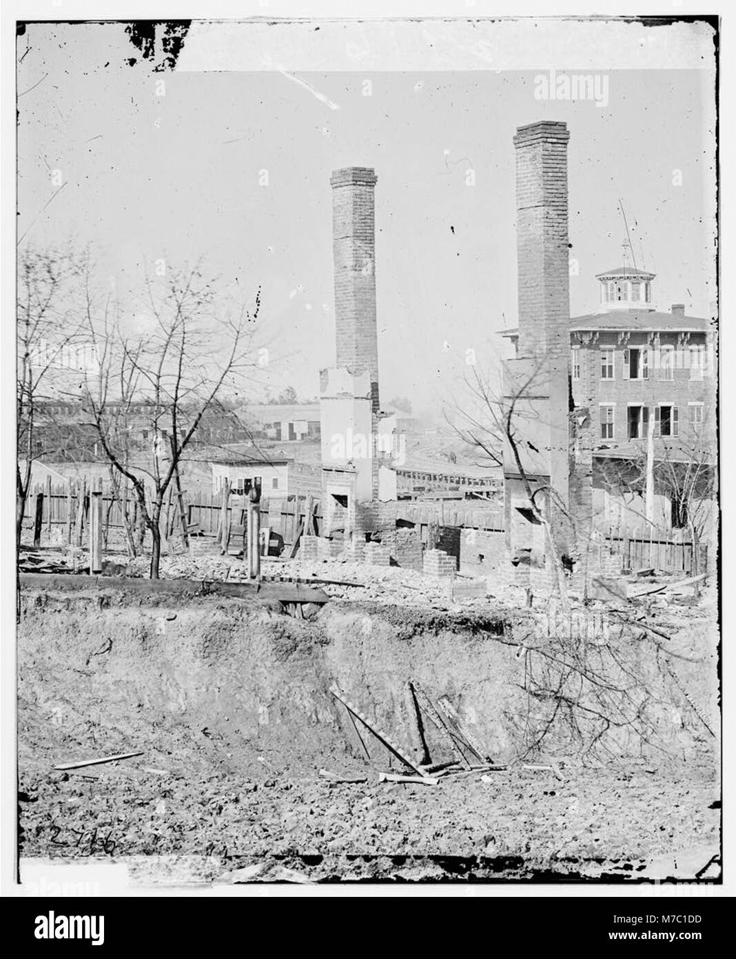 The image shows a burned building in Atlanta, Georgia, likely following ...