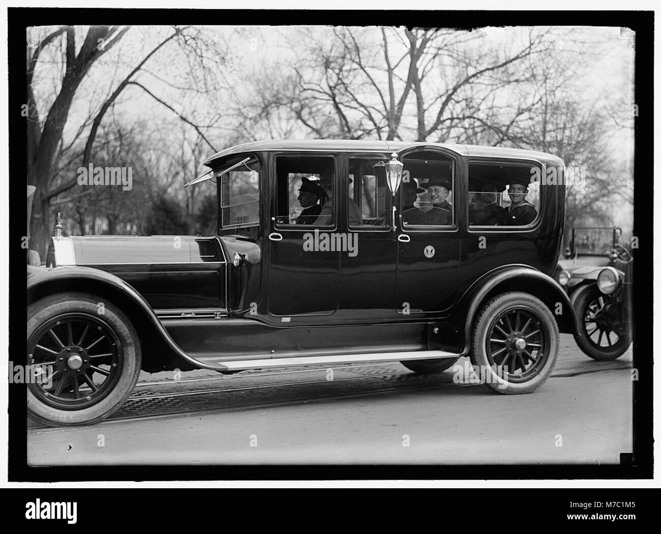 This image shows an early 20th century automobile, representing the ...
