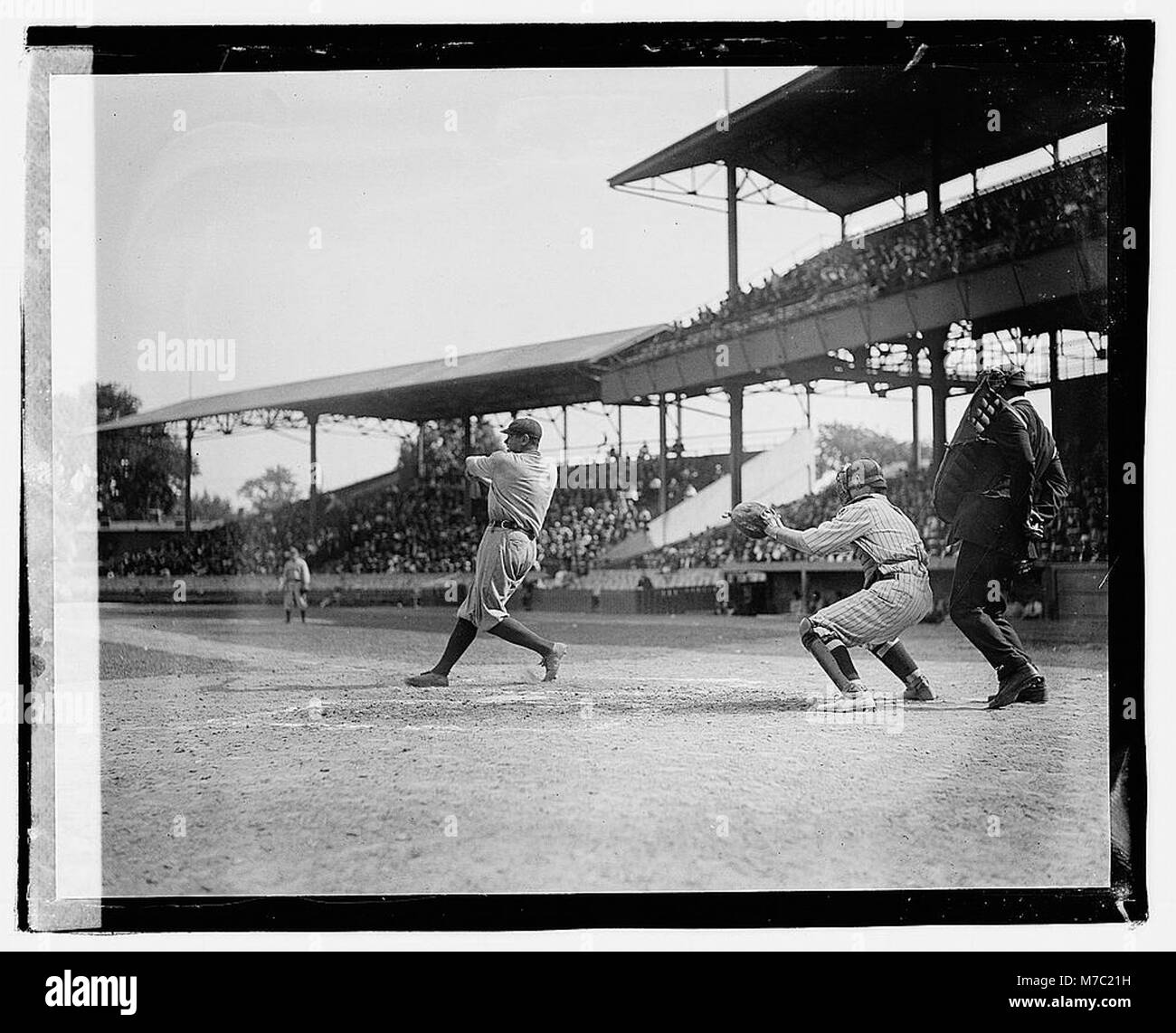 This image captures Babe Ruth at bat during a baseball game, with ...