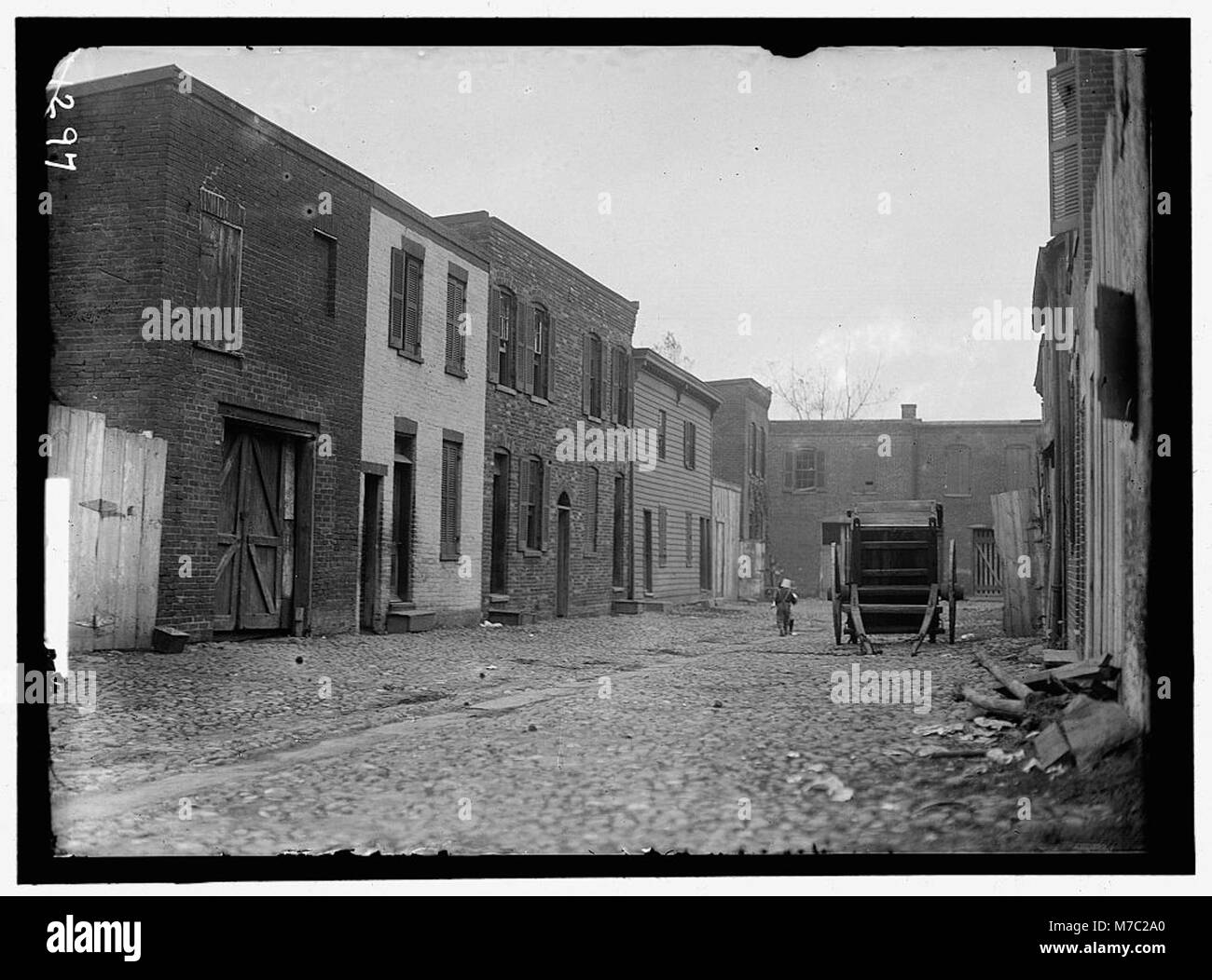 Photographs depicting alley clearance in urban slum areas, illustrating ...