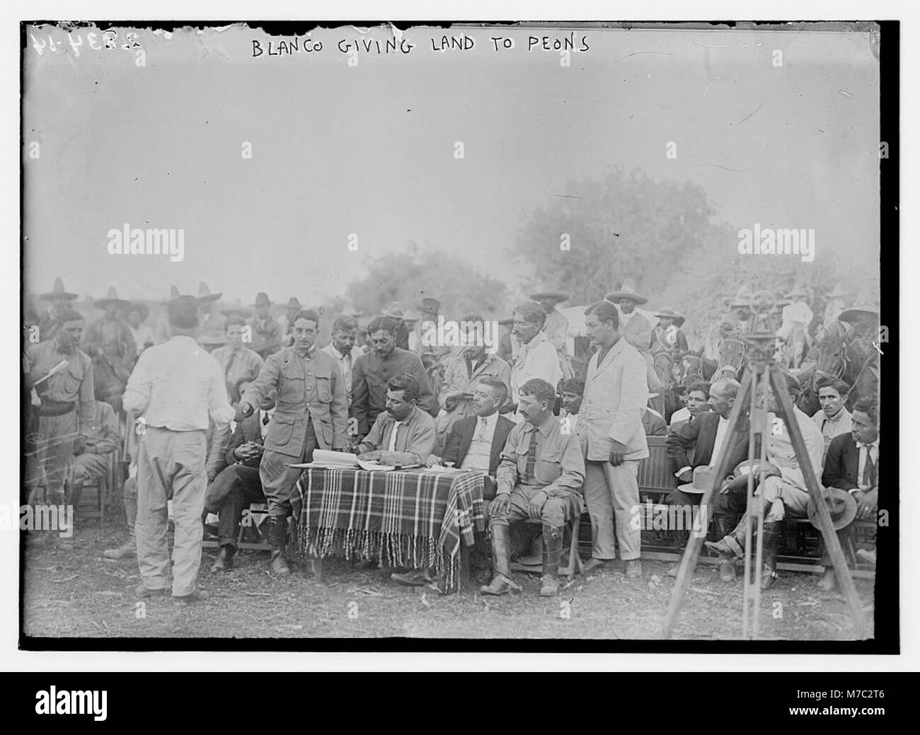 Blanco is depicted in a historical scene giving land to peons in a ...